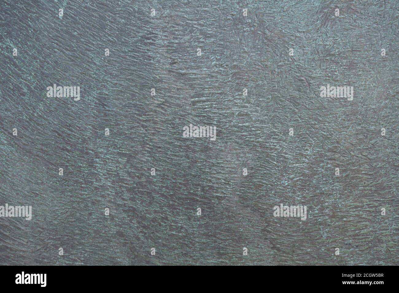 Old bronze structure. Darkened brushed metal at the foot of the ...