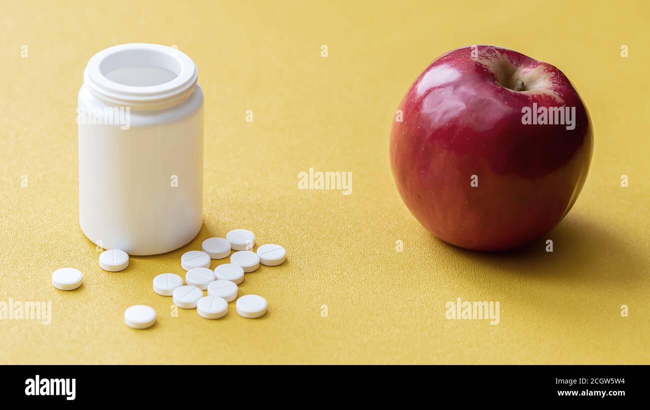 A colorful set of red Apple and pill bottles. Healthy and medicine ...