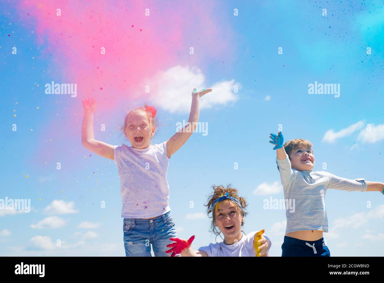 Bright summer colors. Adorable little kids with colored powder and ...