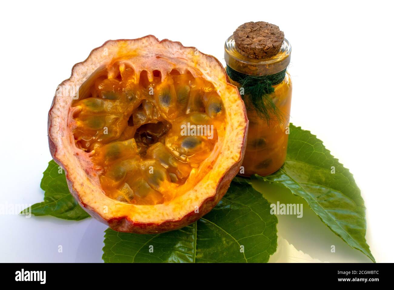 Maracuja cut in half in the bottle and flask and whole with leaf on ...