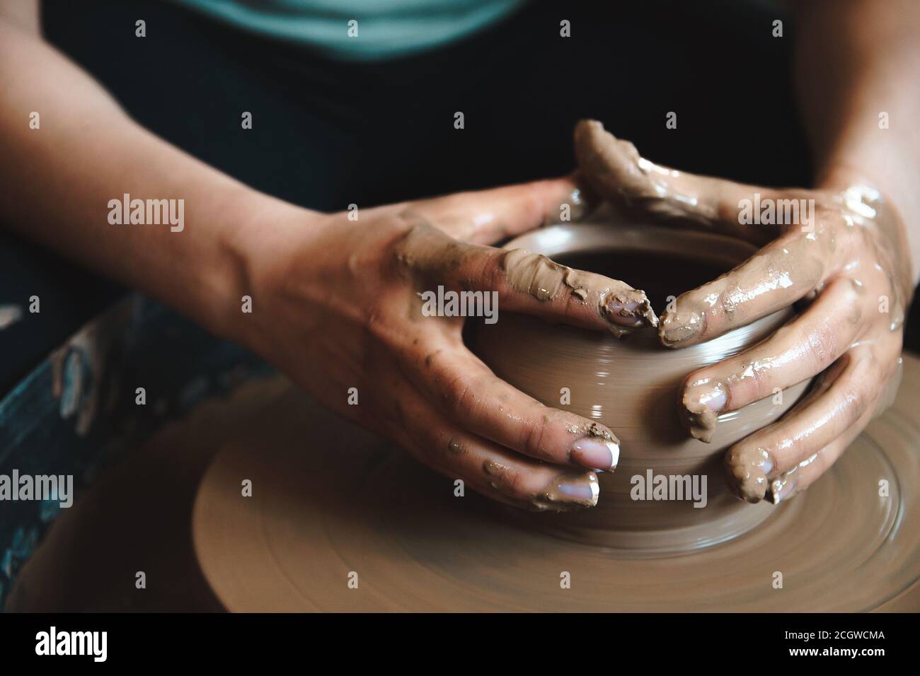 Pottery concept. Professional ceramist working with clay at throwing ...