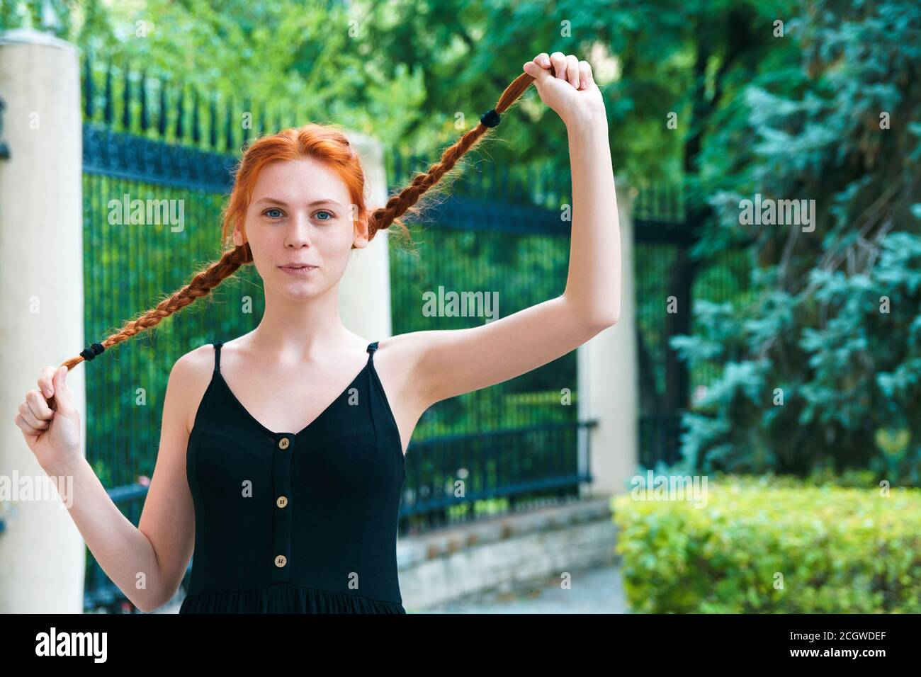 Cute redhead girl playing with hair outdoor. Fun and cheer concept ...