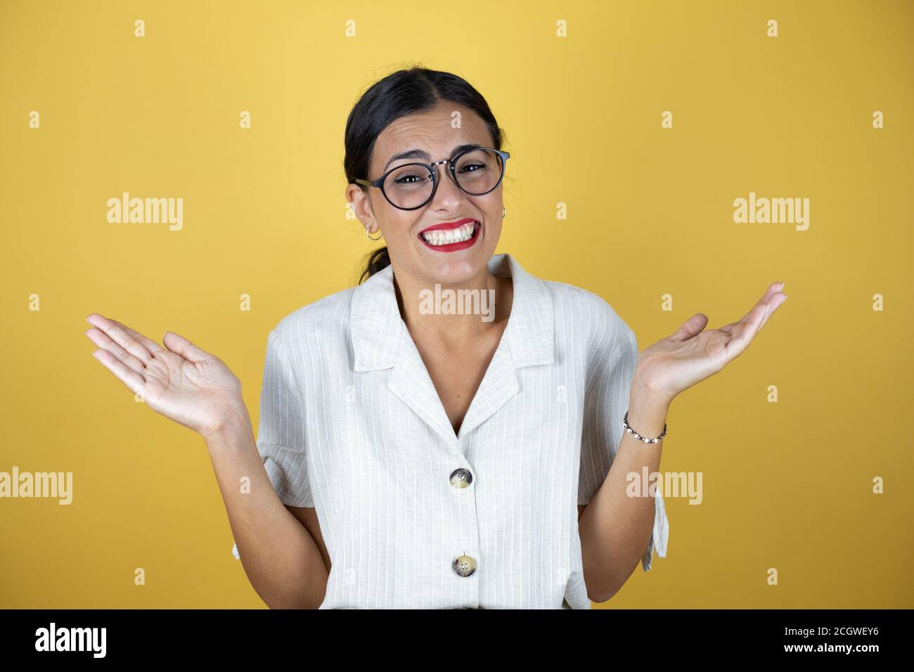 Beautiful woman over yellow background crazy and mad shouting and ...