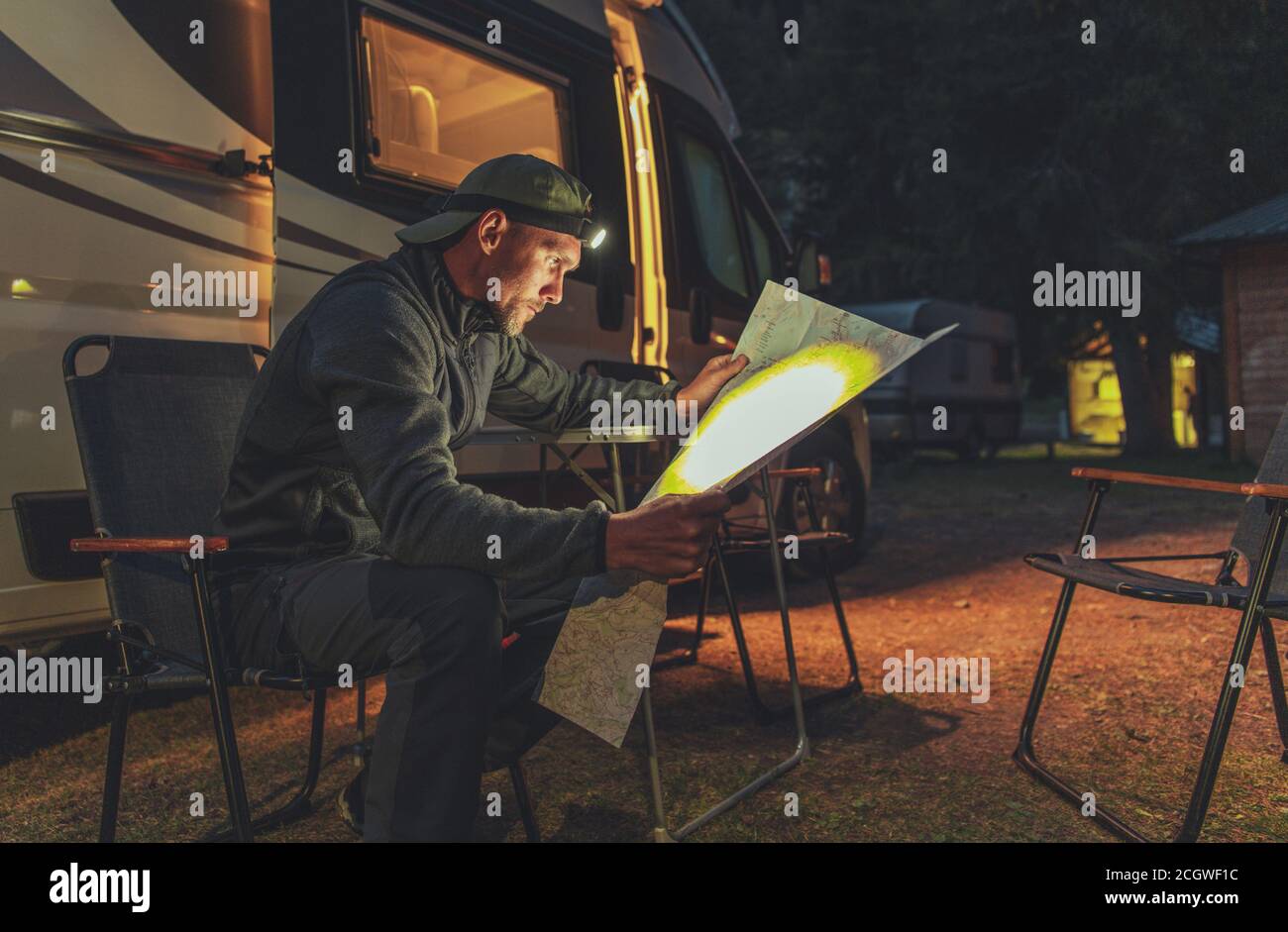Men Planning Next Day Trip While Seating with Map in Front of His ...