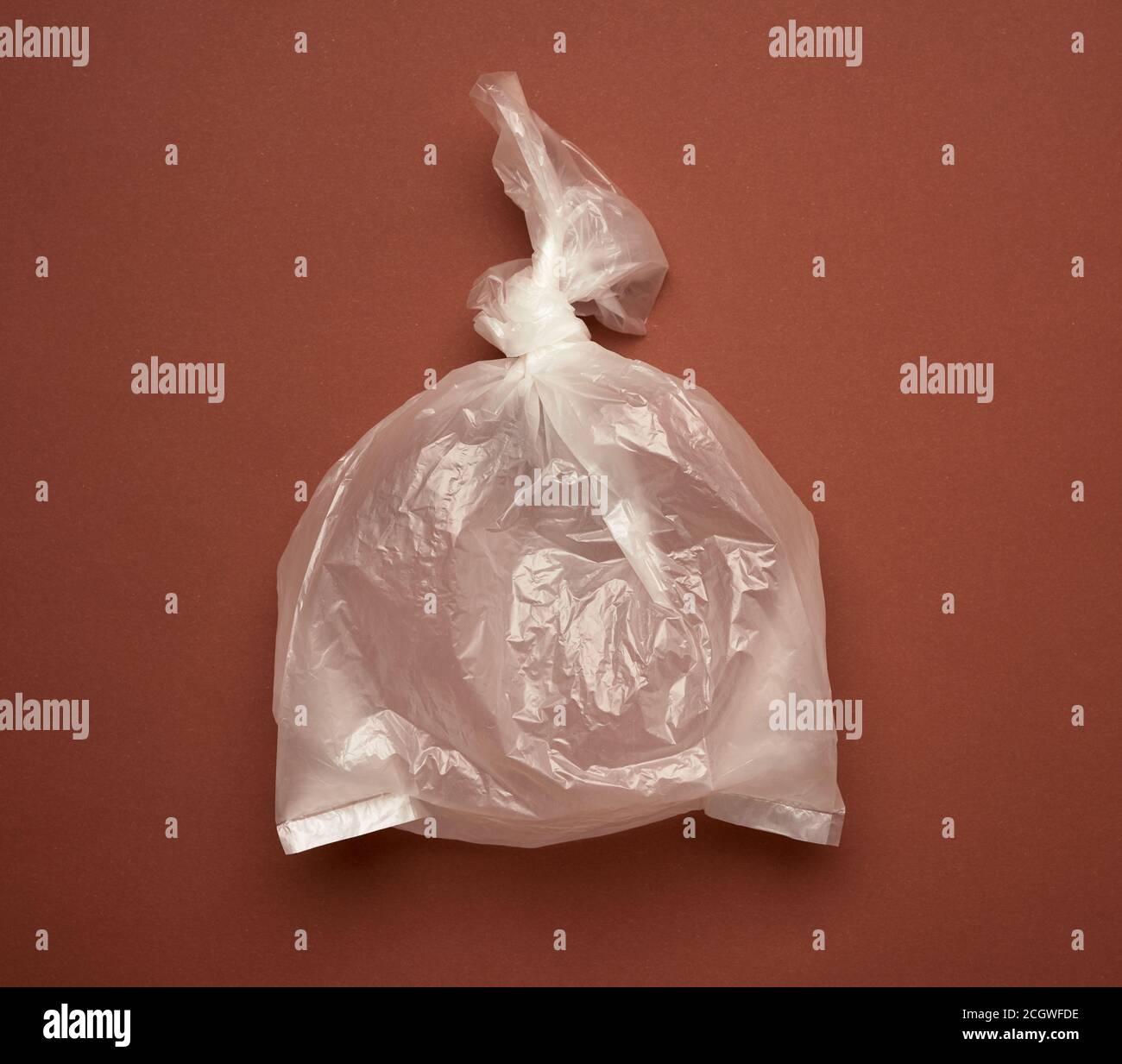 blank transparent plastic bag on brown background, rejection of plastic ...