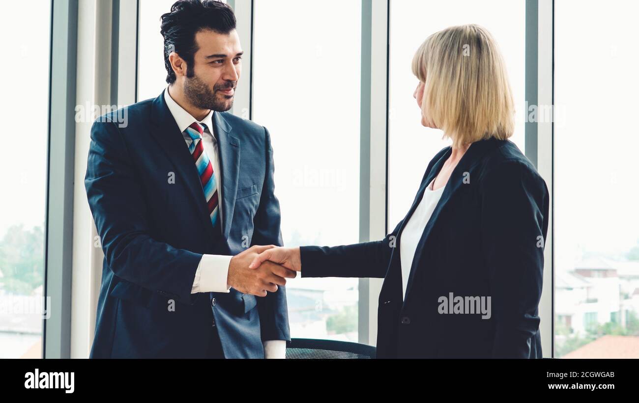 Business people handshake in corporate office showing professional ... Business people handshake in corporate office showing professional ...