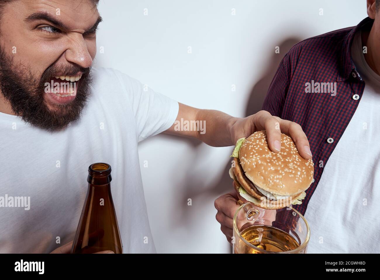 Two friends drink beer leisure fun alcohol friendship lifestyle light ...