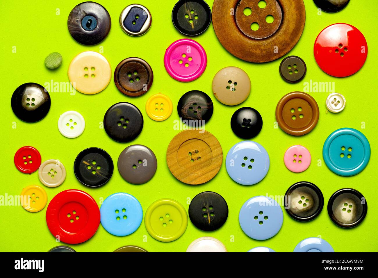 top view of buttons on green colorful background. sewing concept. flat ...
