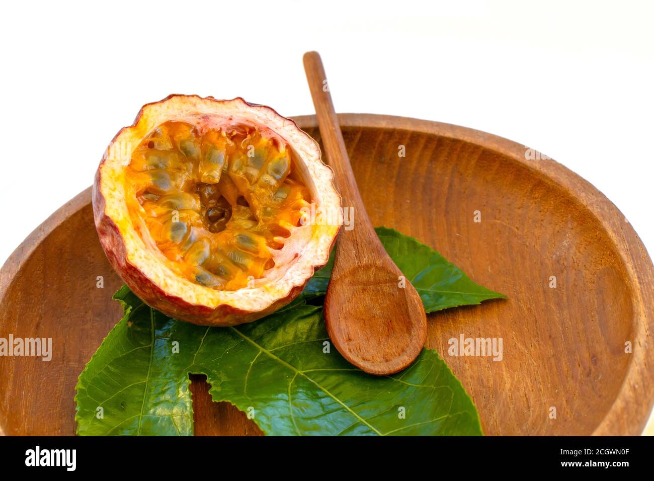 Maracuja cut in half and whole in small glass container peel of the ...