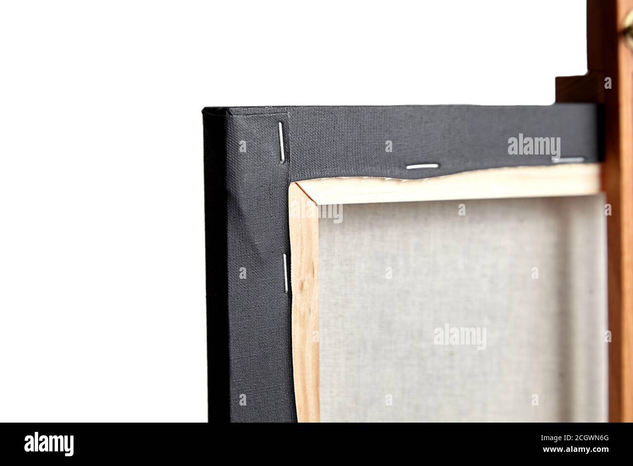 Black cotton canvas stretched on wooden subframe on white background ...