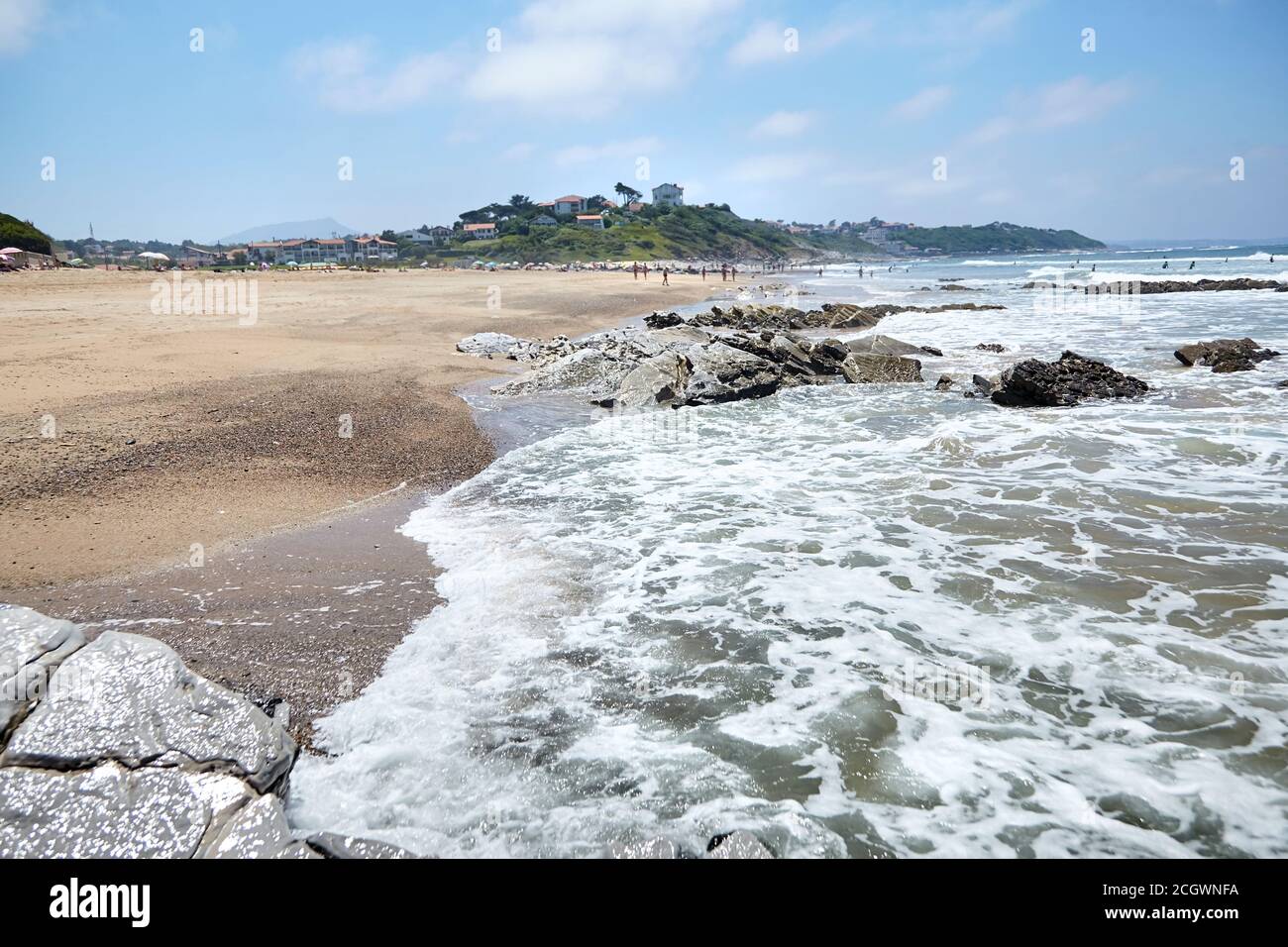 Sandy beach of Bidart, France. Sharp stones and ocean water. Sunny ...