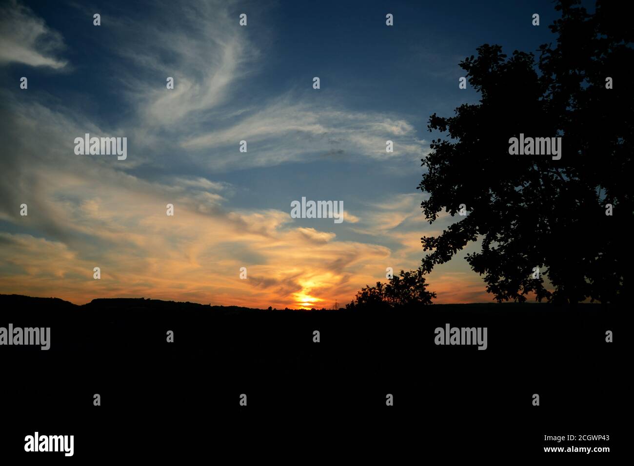 Orange sunset with beautiful clouds Stock Photo - Alamy