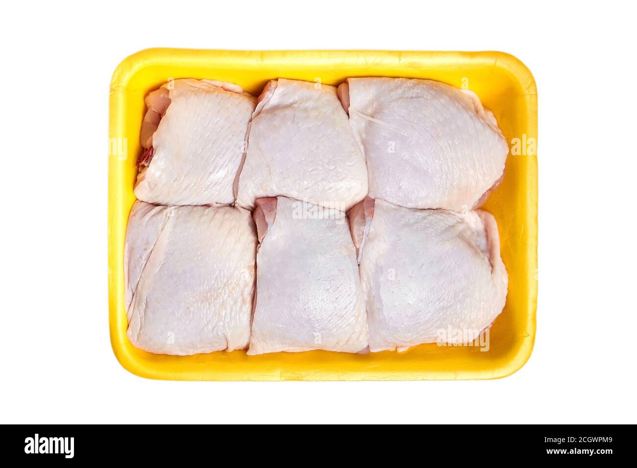 Raw chicken thighs in a yellow plastic container. Meat of poultry in ...