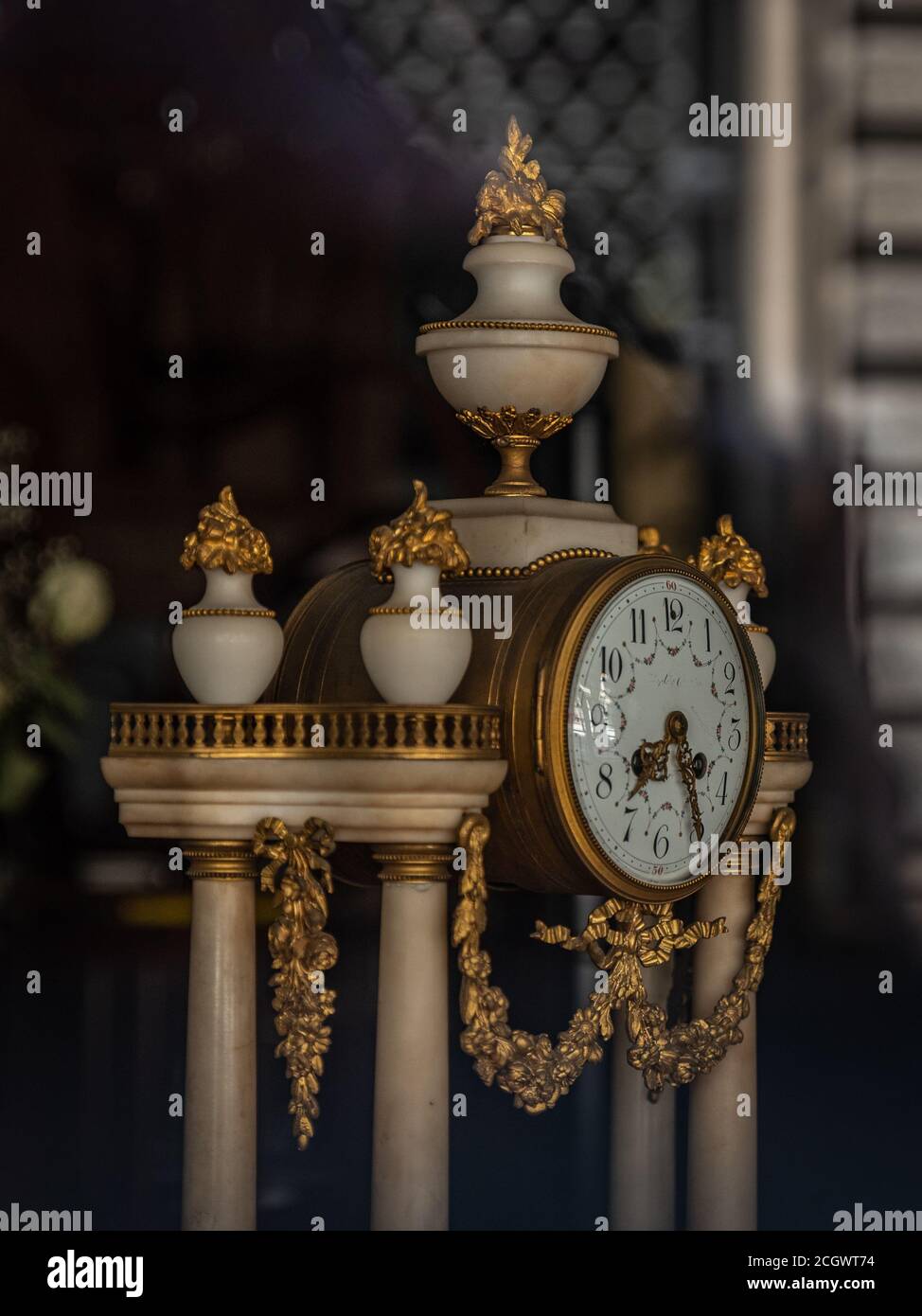 Antique table clock with marble and gold details, historical object ...