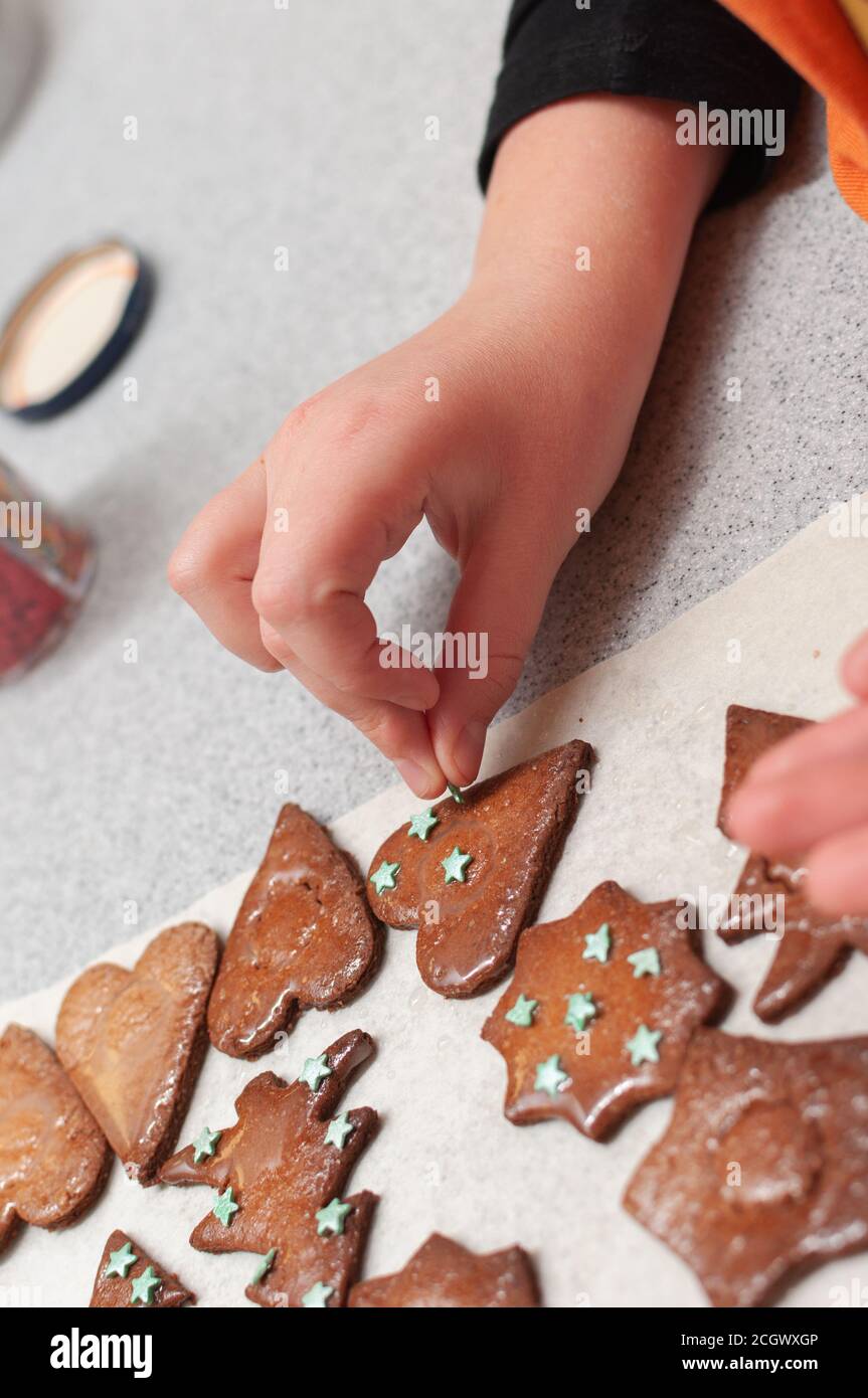 Hand red decorating gingerbread biscuits hi-res stock photography and ...