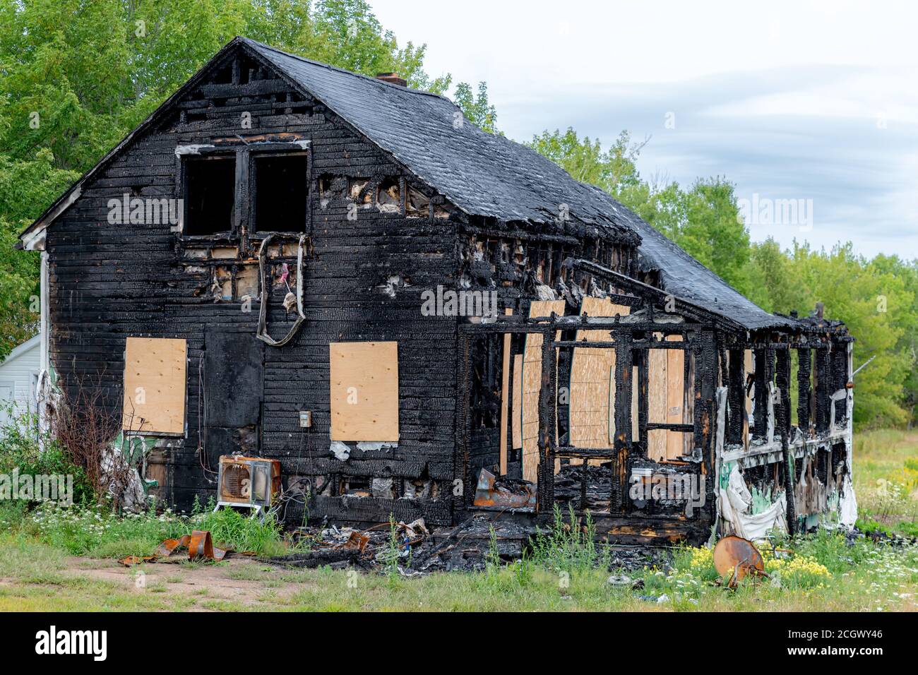A burned house. The outside of the building is completely charred black ...