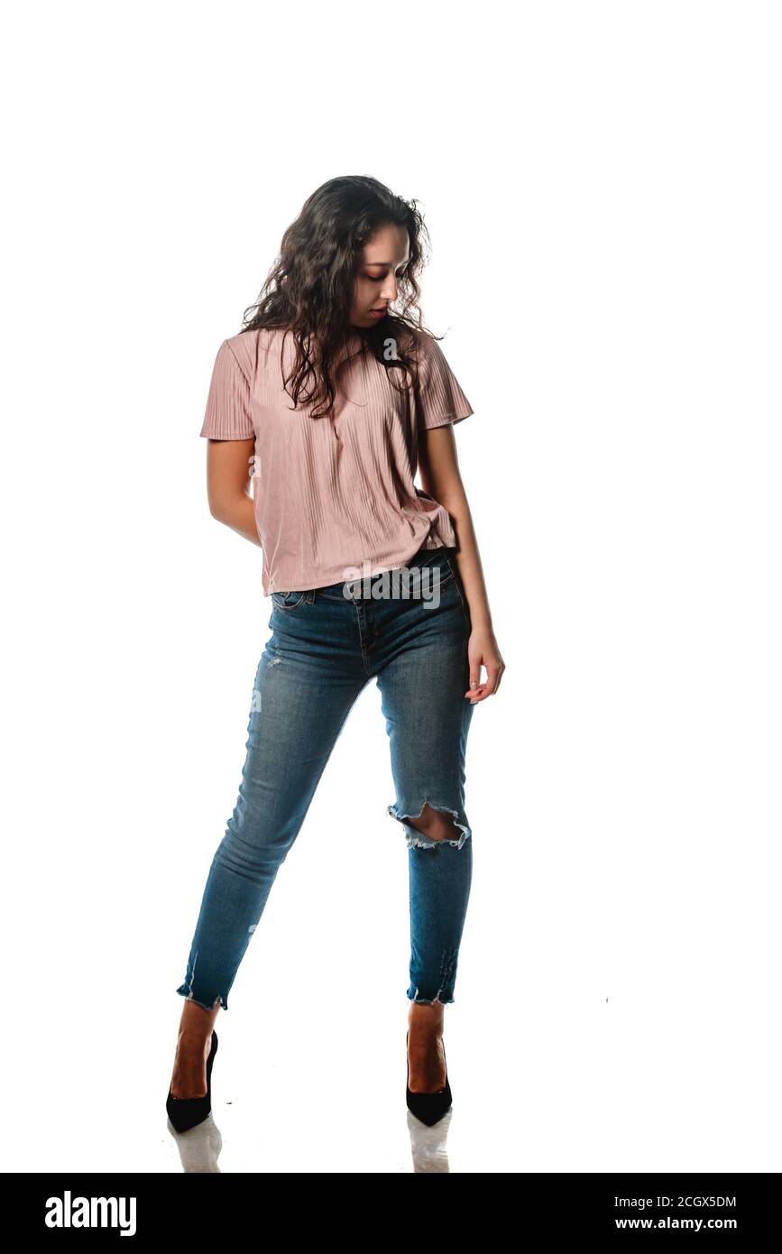 Studio body shot of a fashion female model posing in modern clothing ...