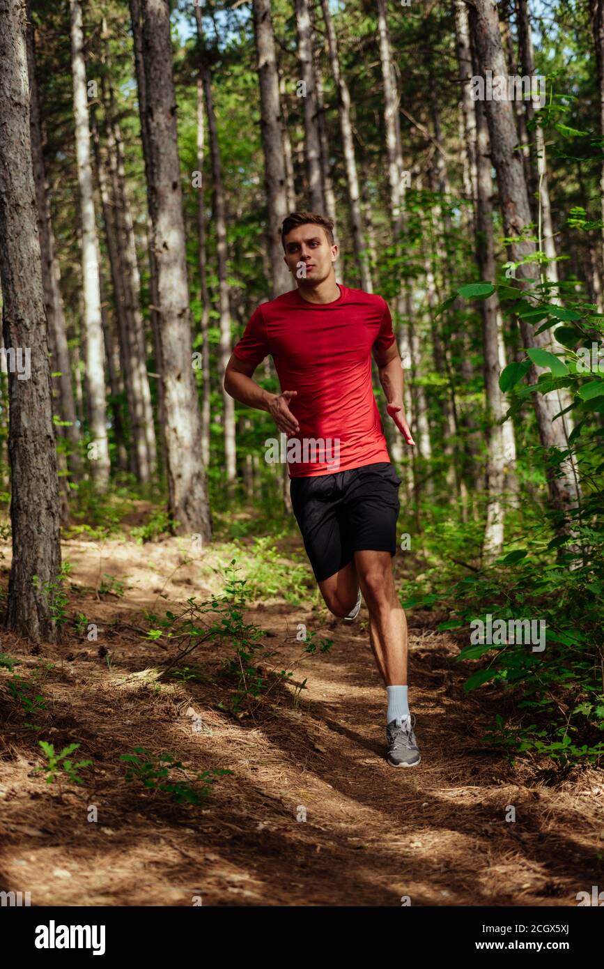 Portrait of a healthy sports man jogging outdoors in nature Stock Photo ...