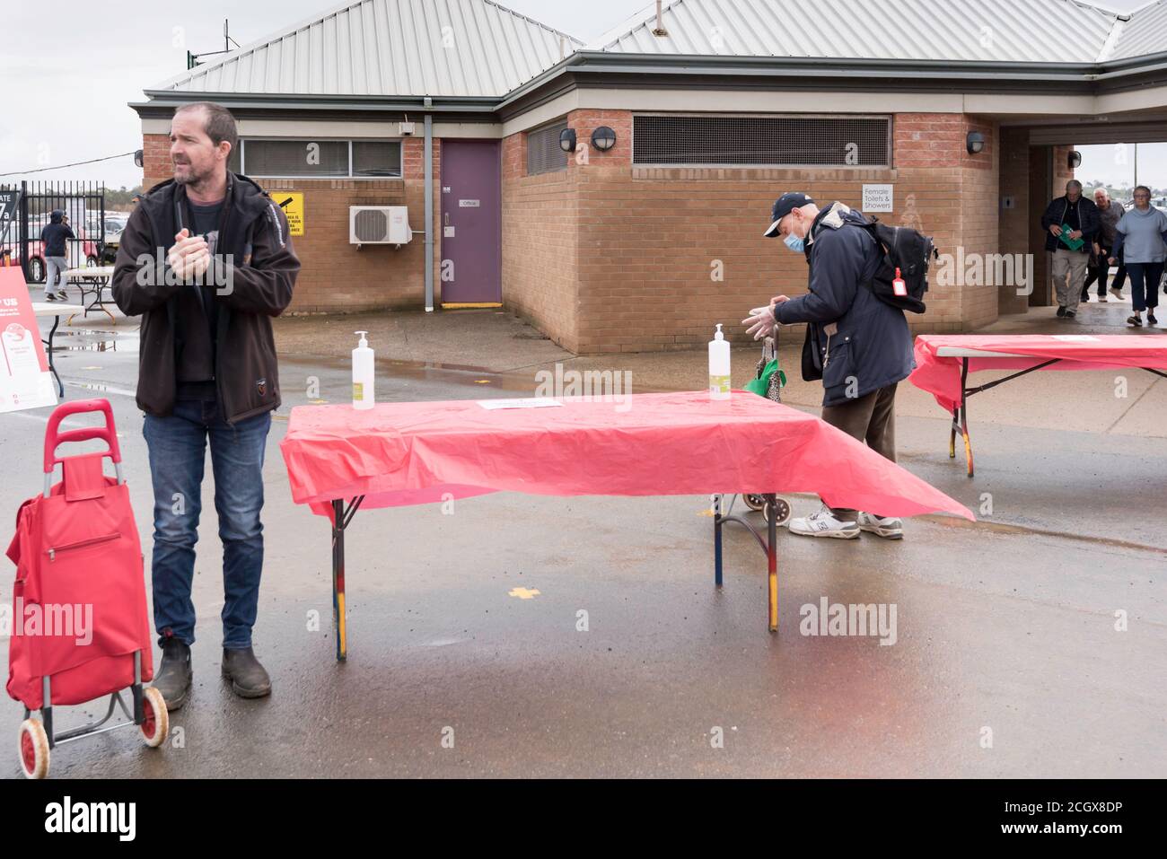 A person using hand sanitiser at the entrance to the Australian Capital ...