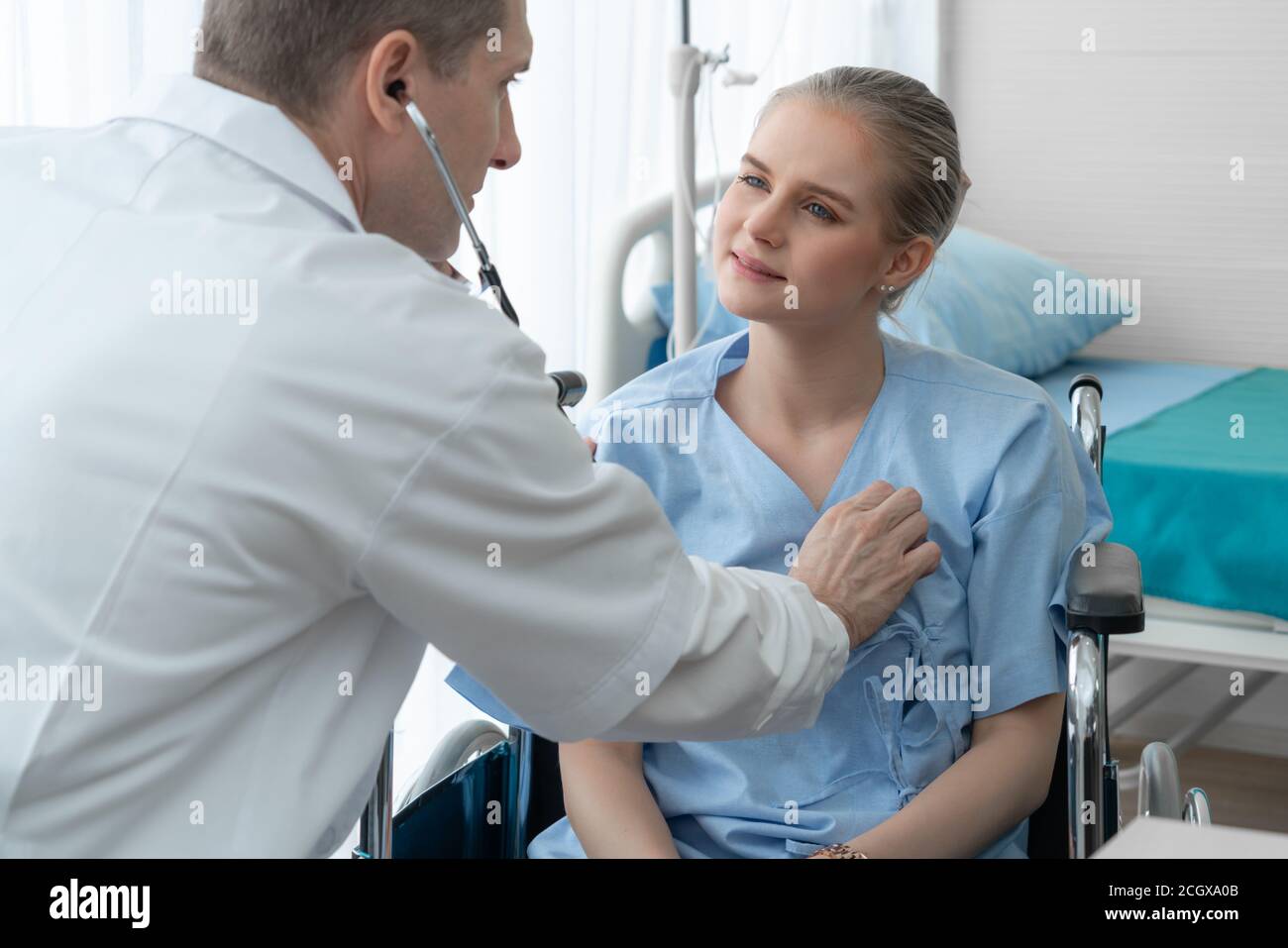 Male doctor examining female patient hi-res stock photography and ...