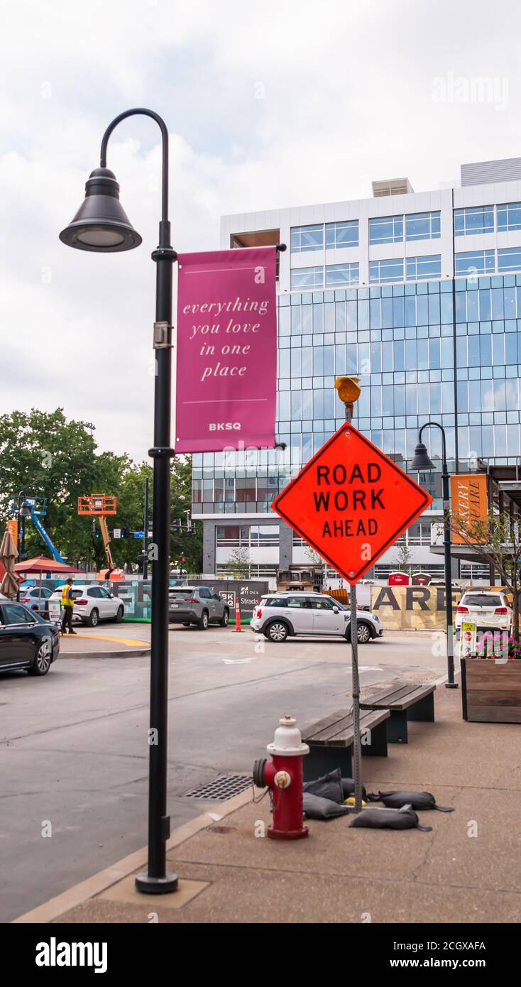 A sign on a light pole and for a construction area in the Bakery Square ...