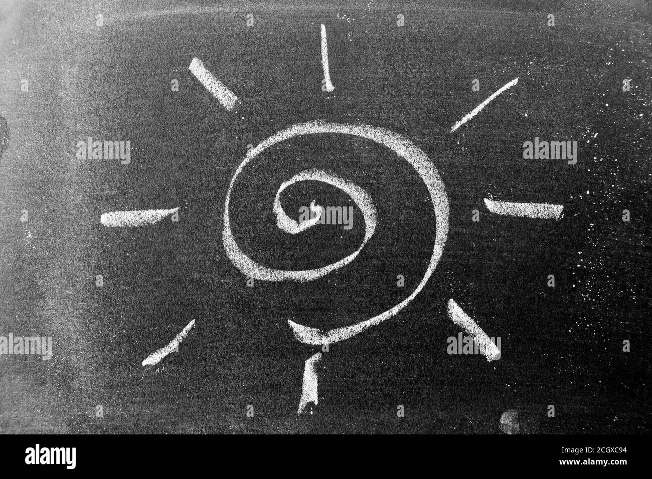 White color chalk hand drawing in sprial sun with ray shape on ...