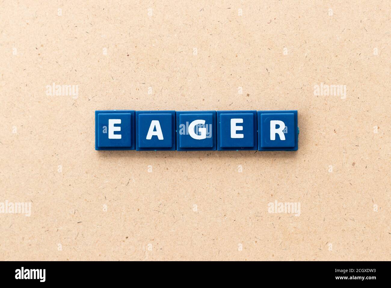 Tile letter in word eager on wood background Stock Photo - Alamy