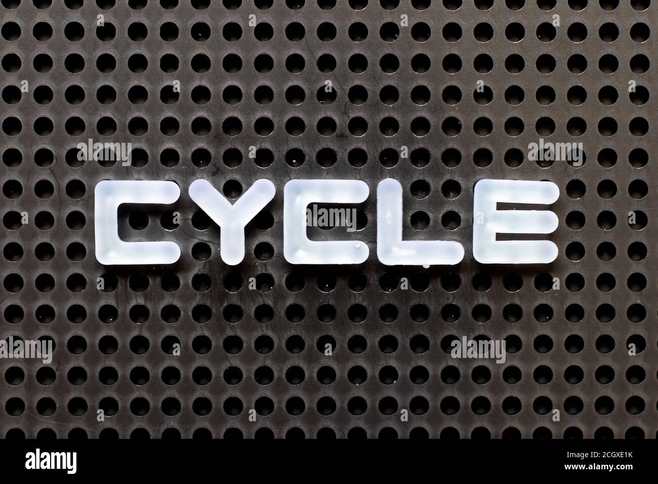 White color alphabet with word cycle on black pegboard background Stock ...