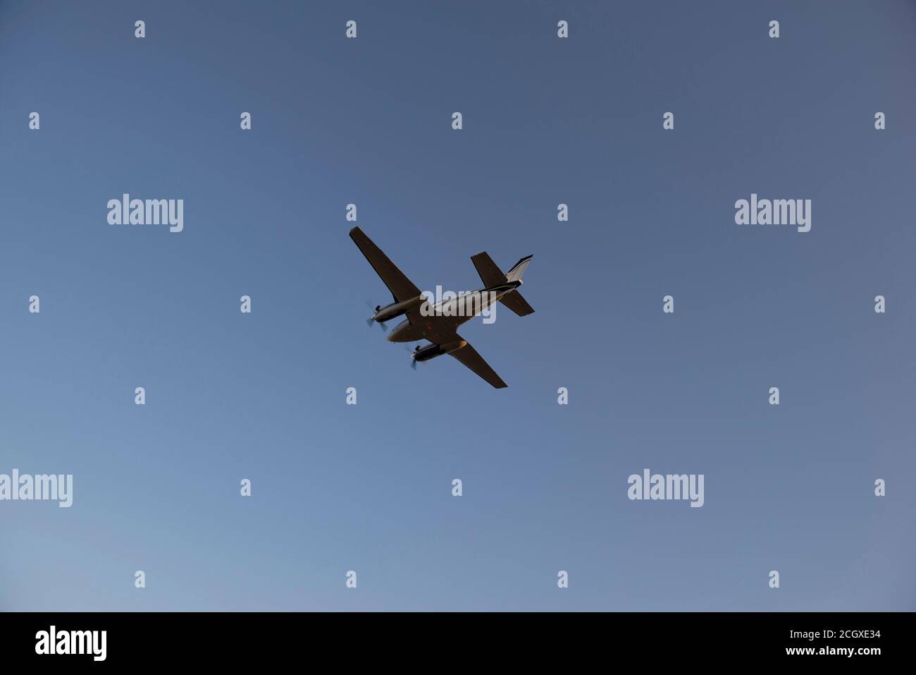 Bottom view of propeller-powered airplane taking off from the airport ... Bottom view of propeller-powered airplane taking off from the airport ...