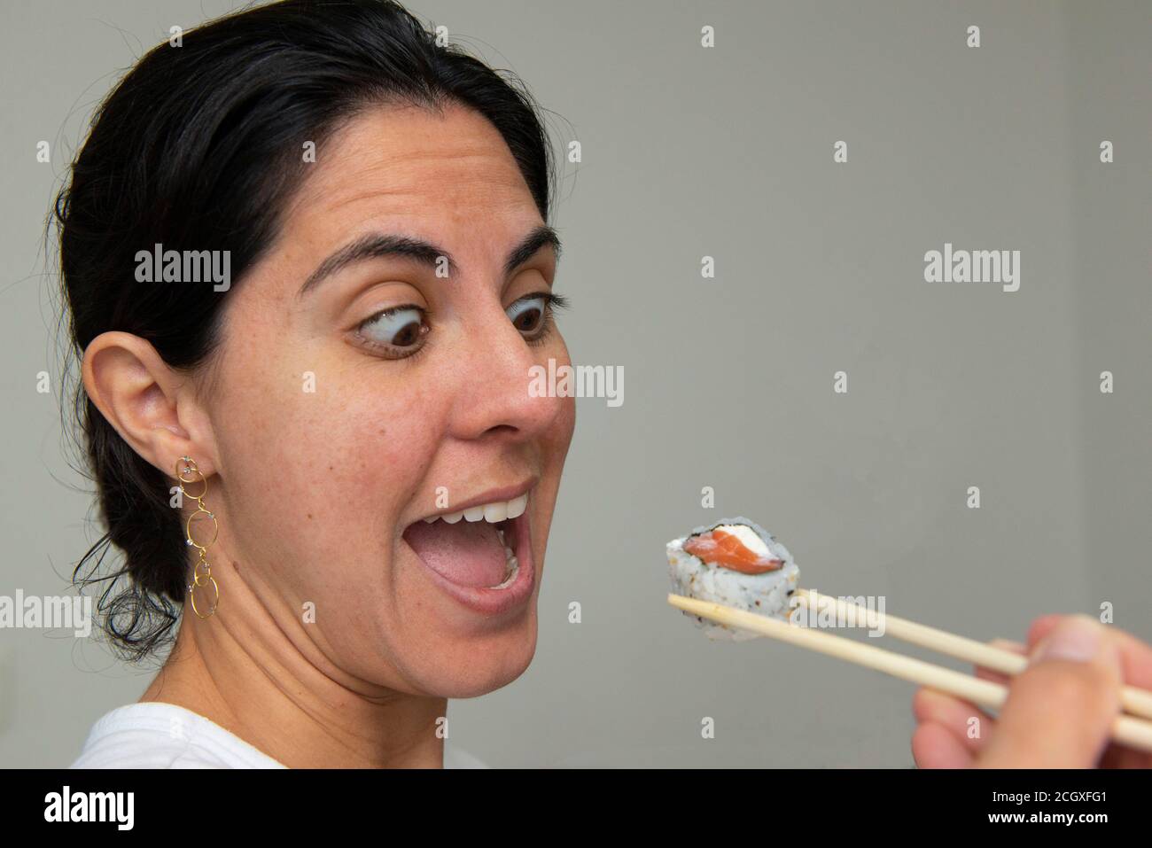 Woman eats sushi rolls hi-res stock photography and images - Alamy