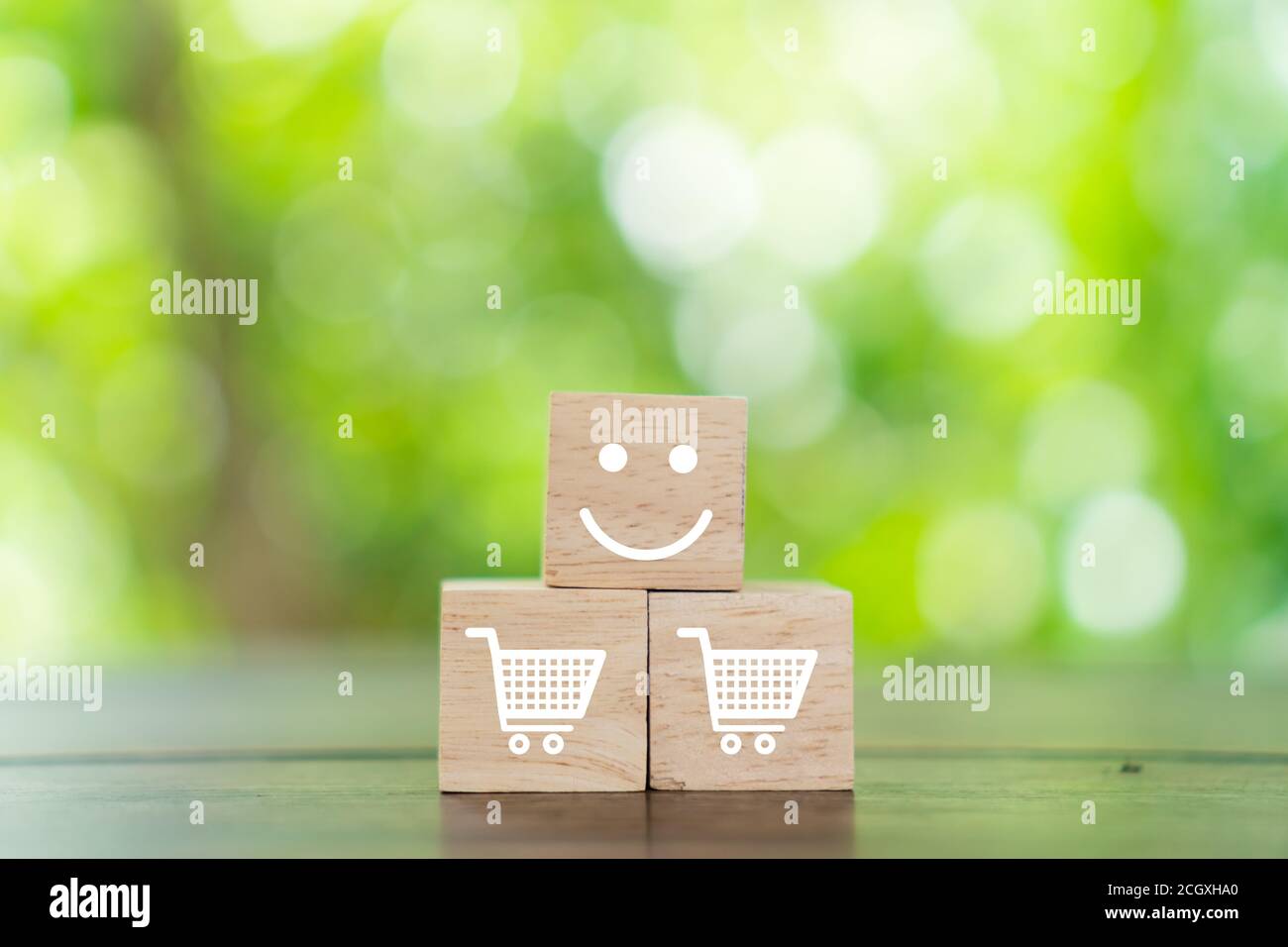Smile face and cart icon on wood cube. Optimistic person or people ...