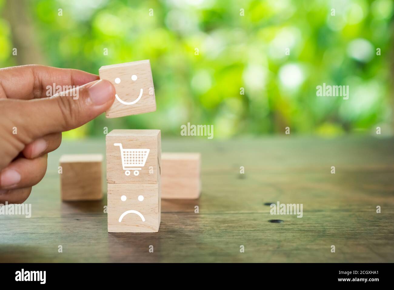 Smile face and cart icon on wood cube. Optimistic person or people ...