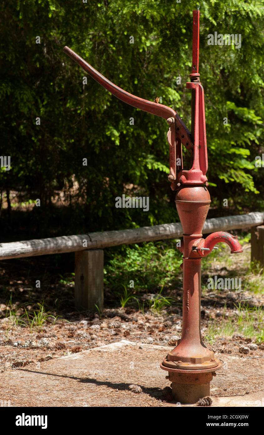 A rustic hand-operated water pump at a US Forest Service campground ...