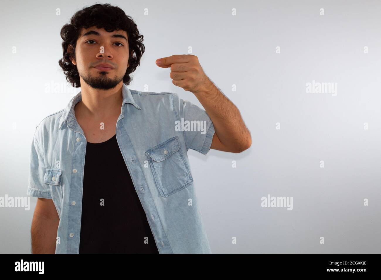 young hispanic deaf man using sign language to communicate, on a white ...