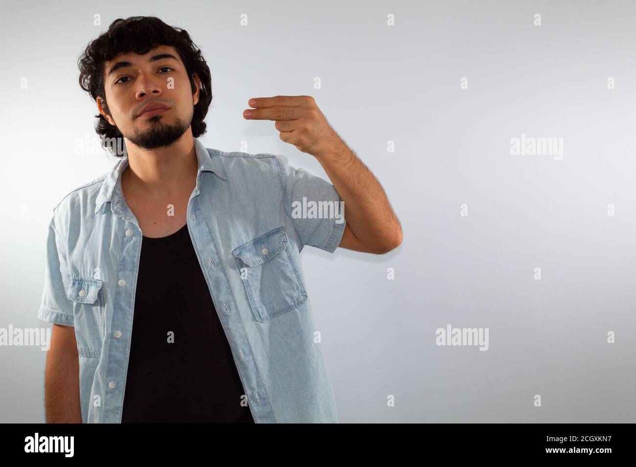 young hispanic deaf man using sign language to communicate, on a white ...
