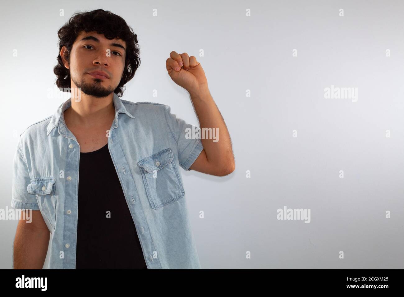 young hispanic deaf man using sign language to communicate, on a white ...