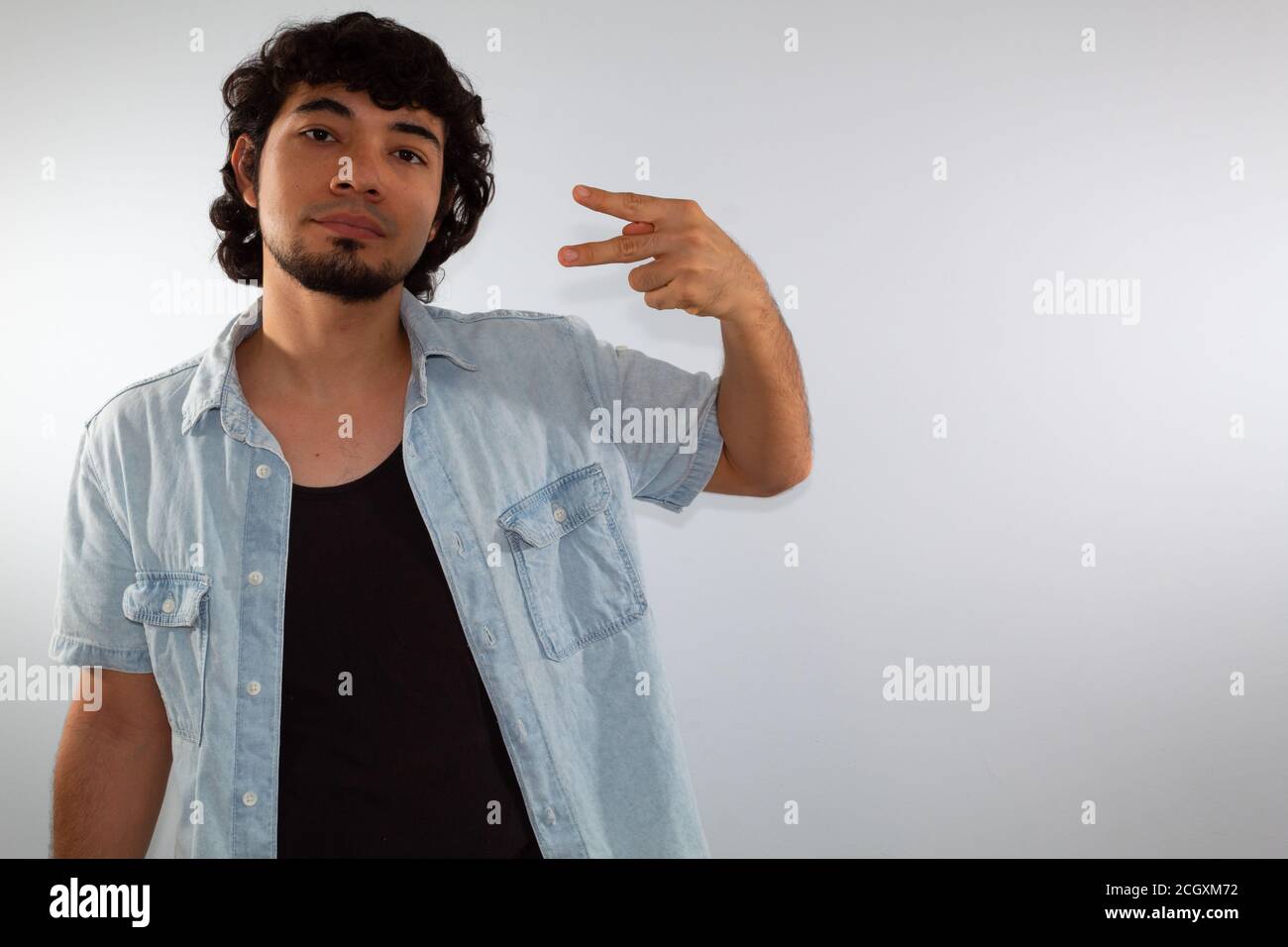 young hispanic deaf man using sign language to communicate, on a white ...