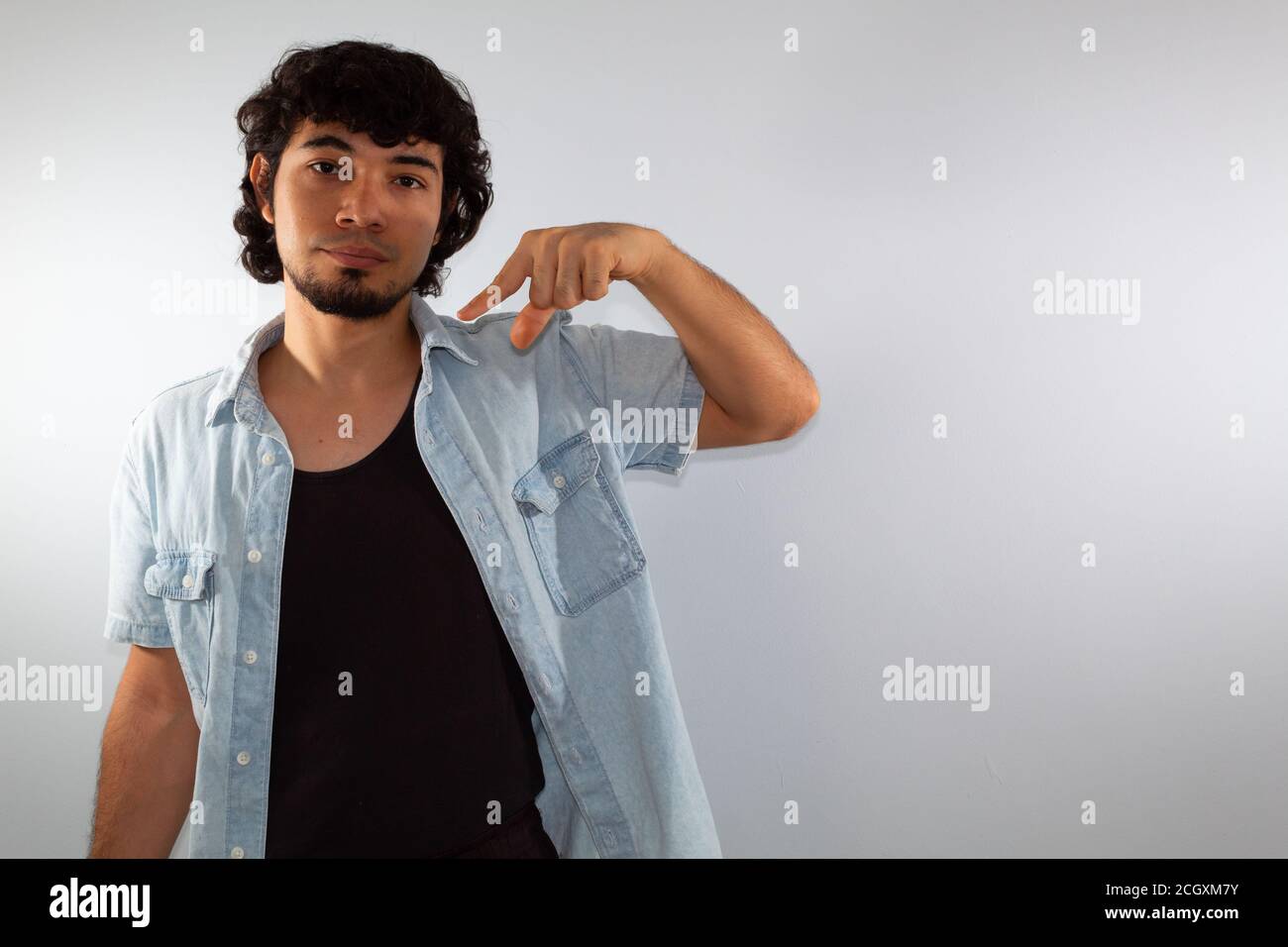 young hispanic deaf man using sign language to communicate, on a white ...