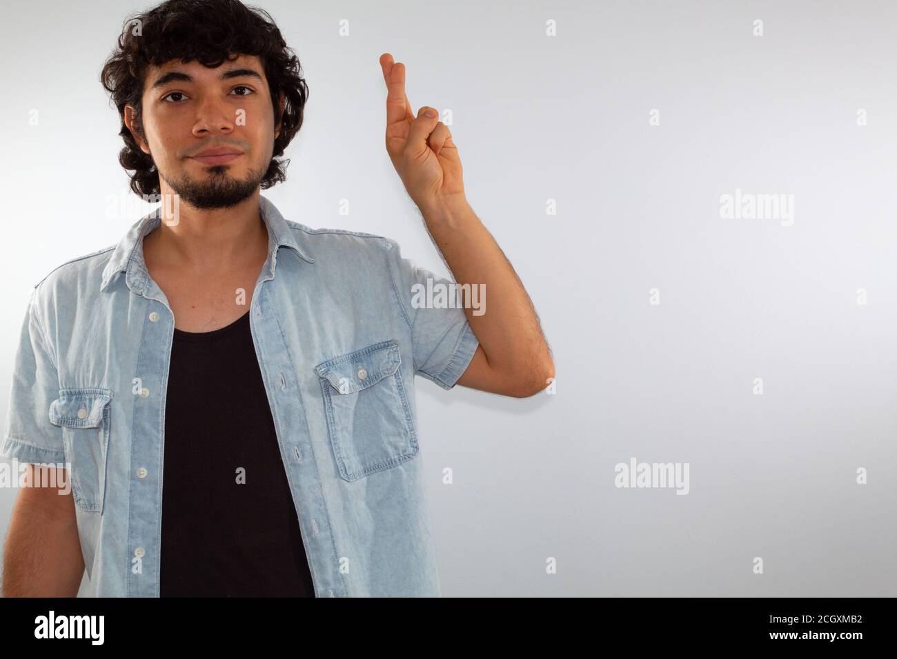 young hispanic deaf man using sign language to communicate, on a white ...
