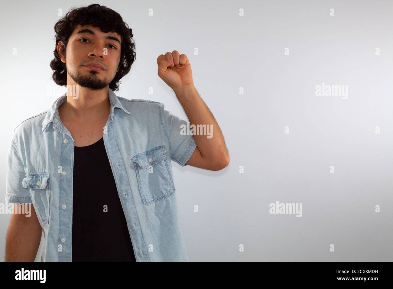 young hispanic deaf man using sign language to communicate, on a white ...