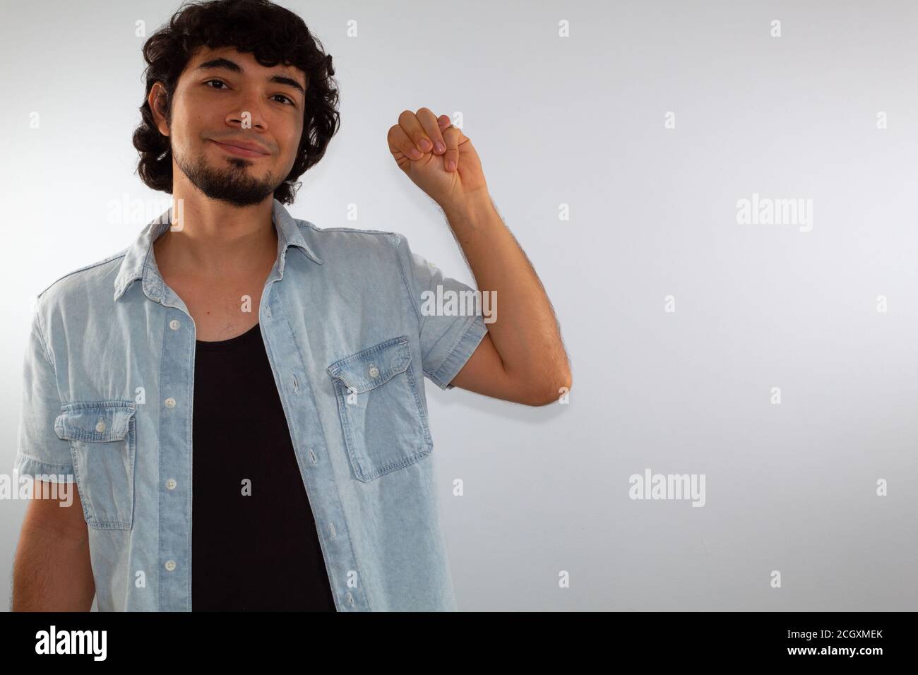 young hispanic deaf man using sign language to communicate, on a white ...