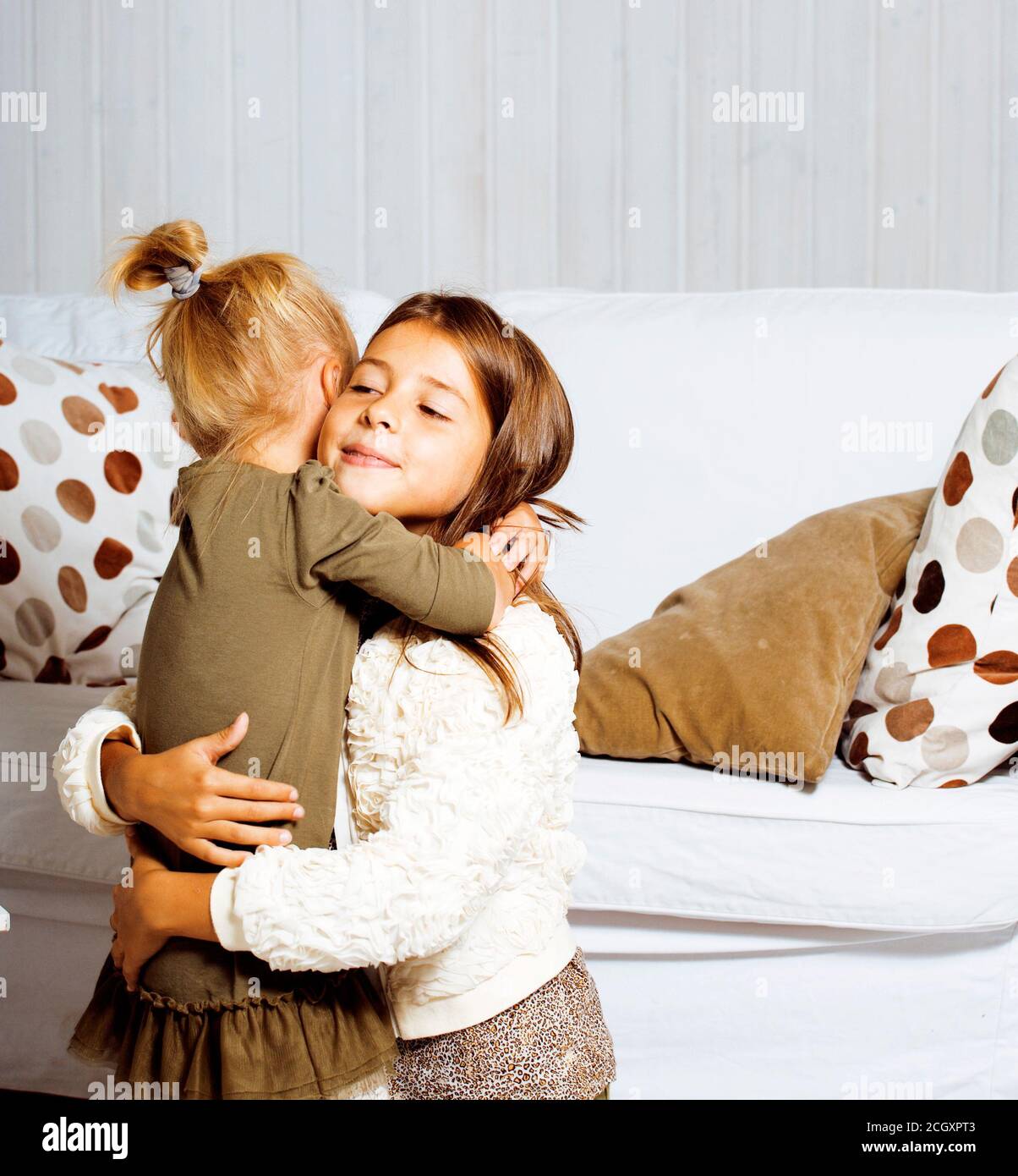 two cute sisters at home playing, little smiling girl in house interior ...