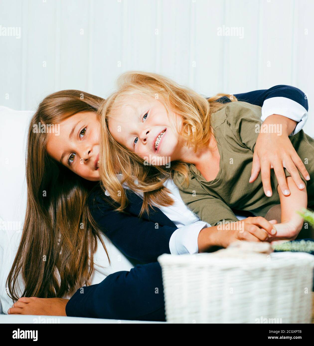 two cute sisters at home interior playing, little happy smiling girl in ...