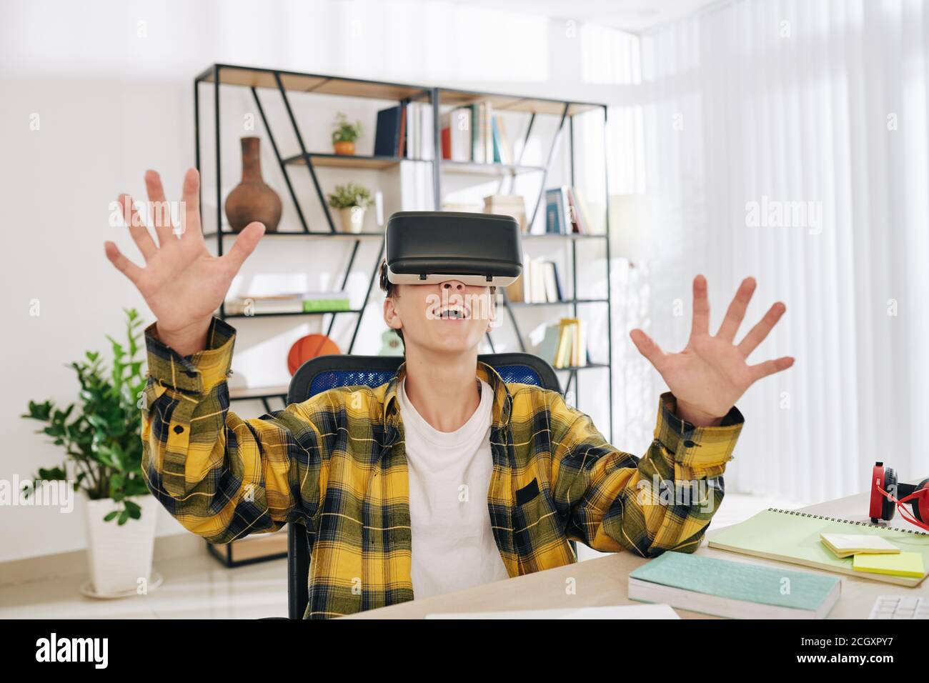 Boy enjoying playing VR game Stock Photo - Alamy