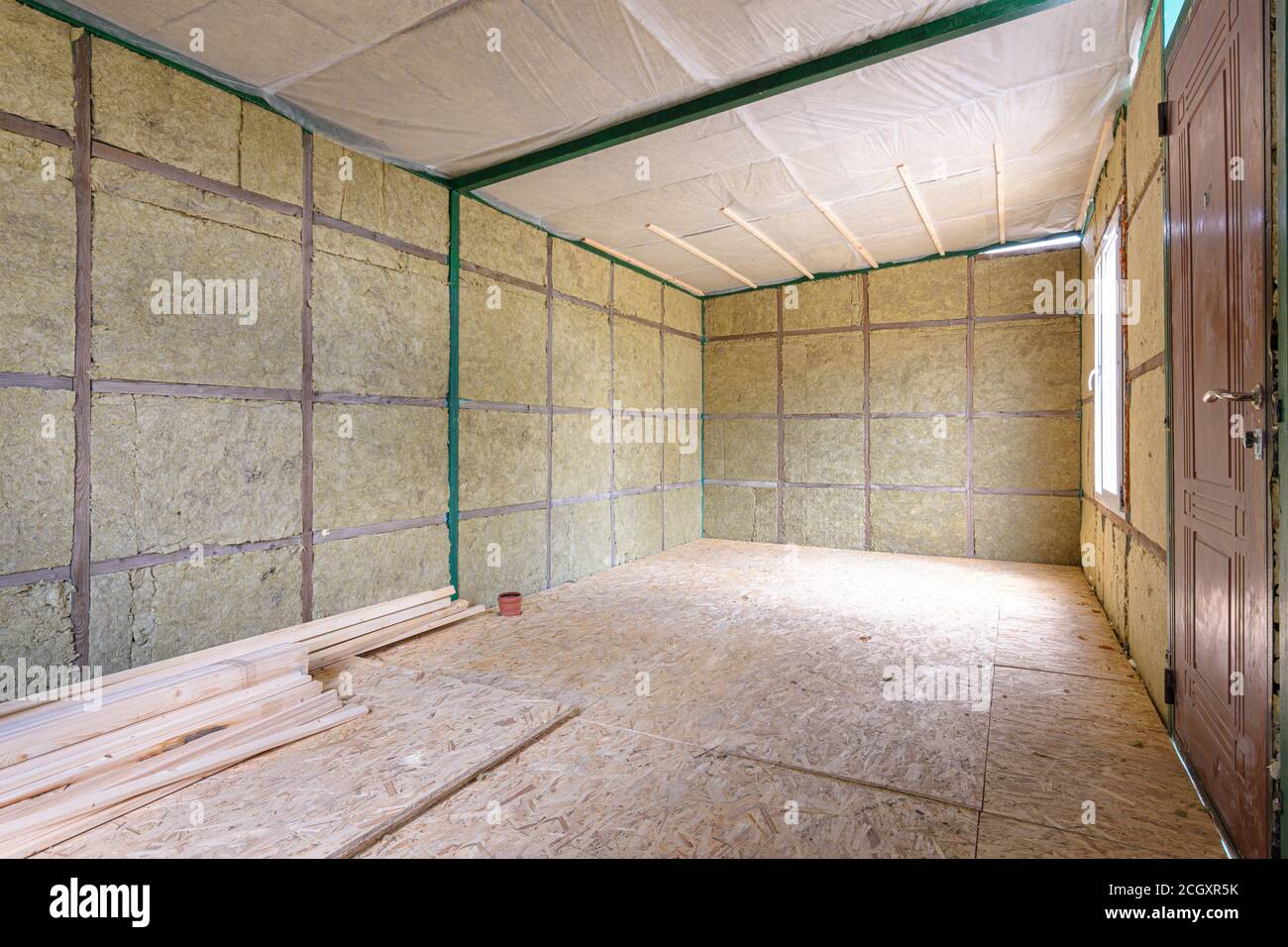 The interior of a suburban room under construction, insulated from the ...