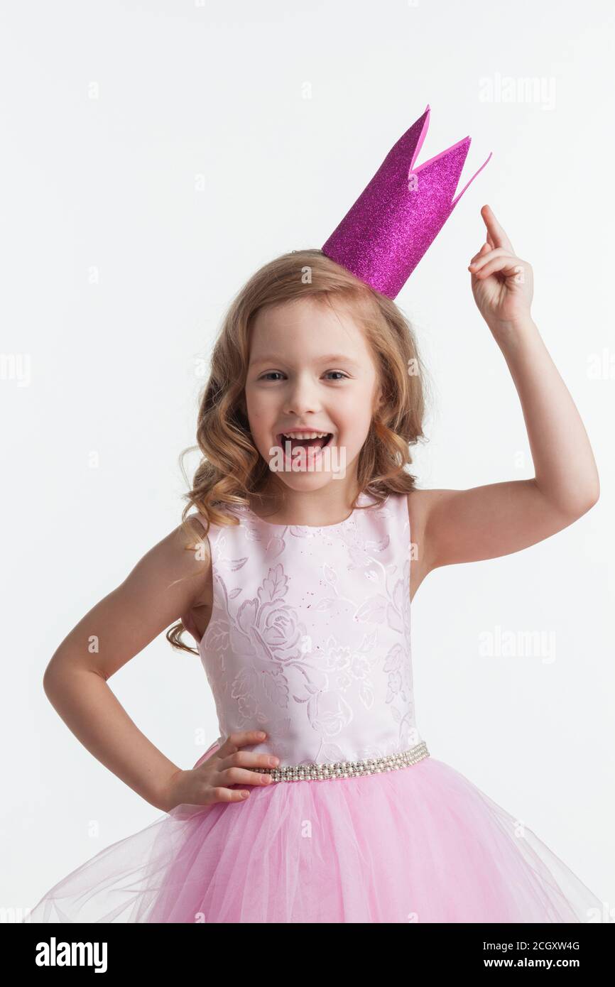 Funny princess girl in pink dress and crown with finger up isolated on ...