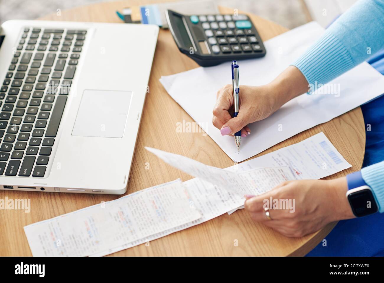 Woman calculating expences Stock Photo - Alamy