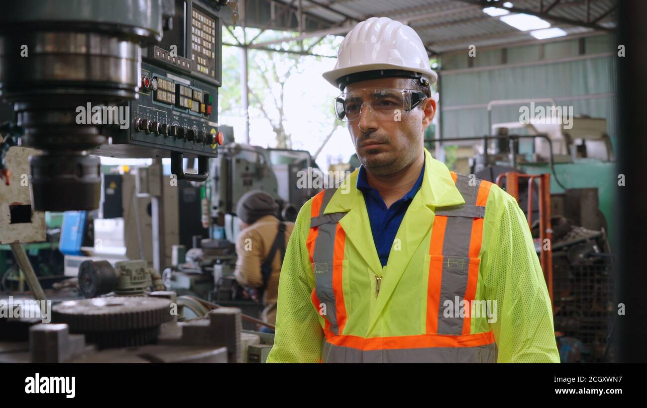 Smart factory worker using machine in factory workshop . Industry and ...