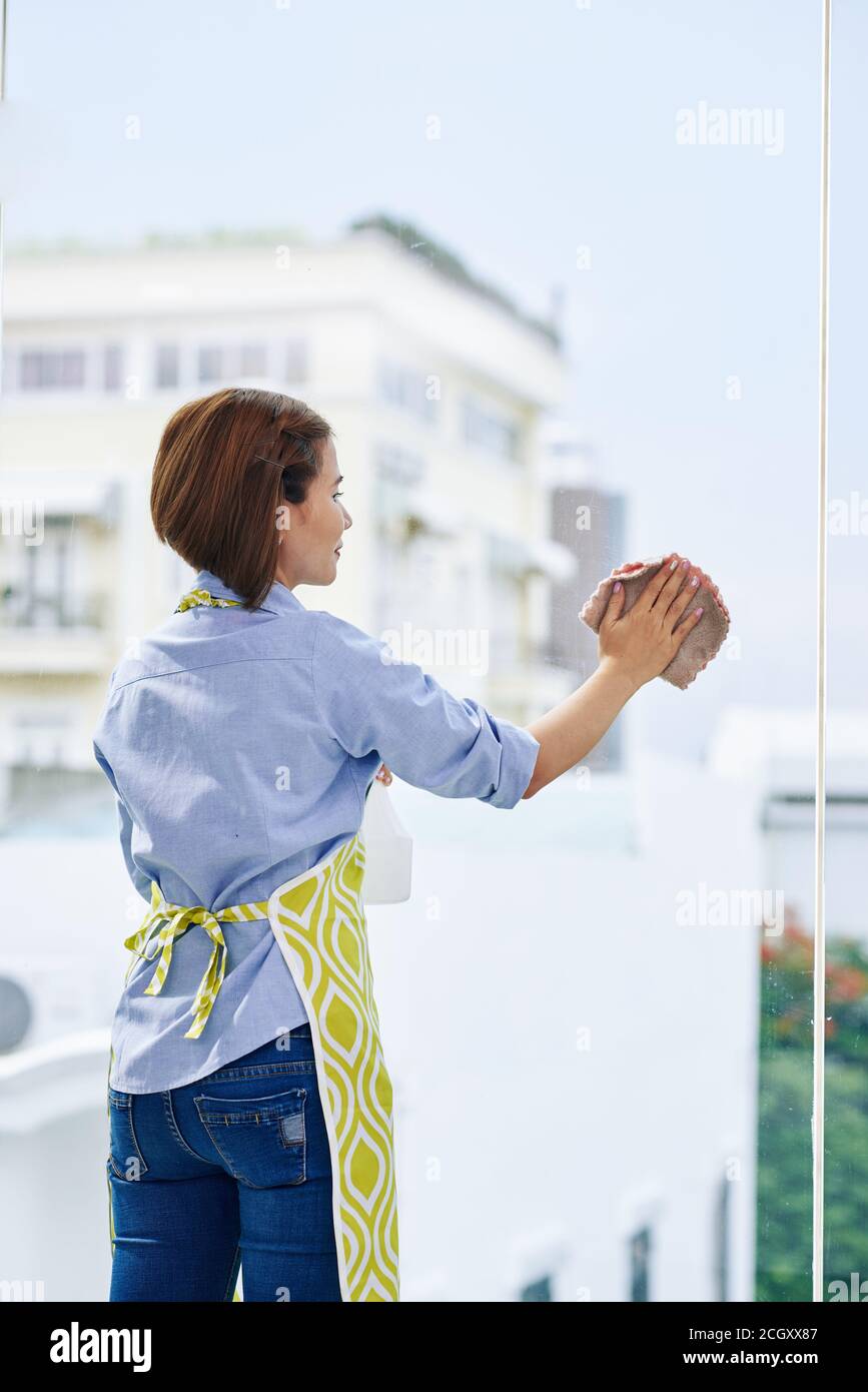 WOman cleaning big window Stock Photo - Alamy