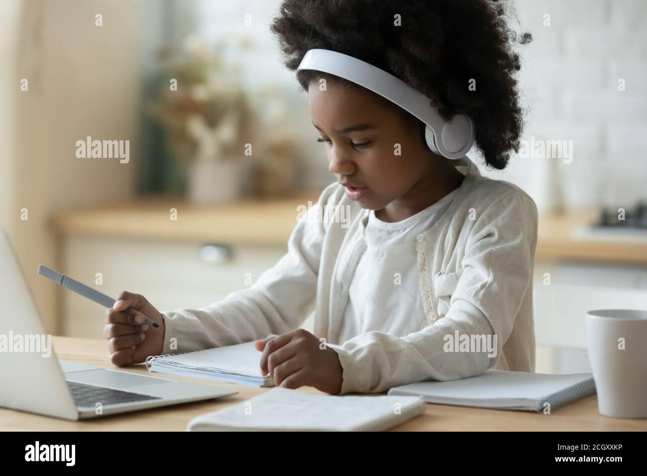 African american small child checking tasks at online school class ...